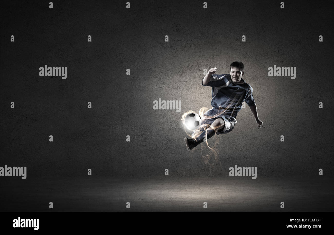 Football player in high jump taking ball Stock Photo - Alamy