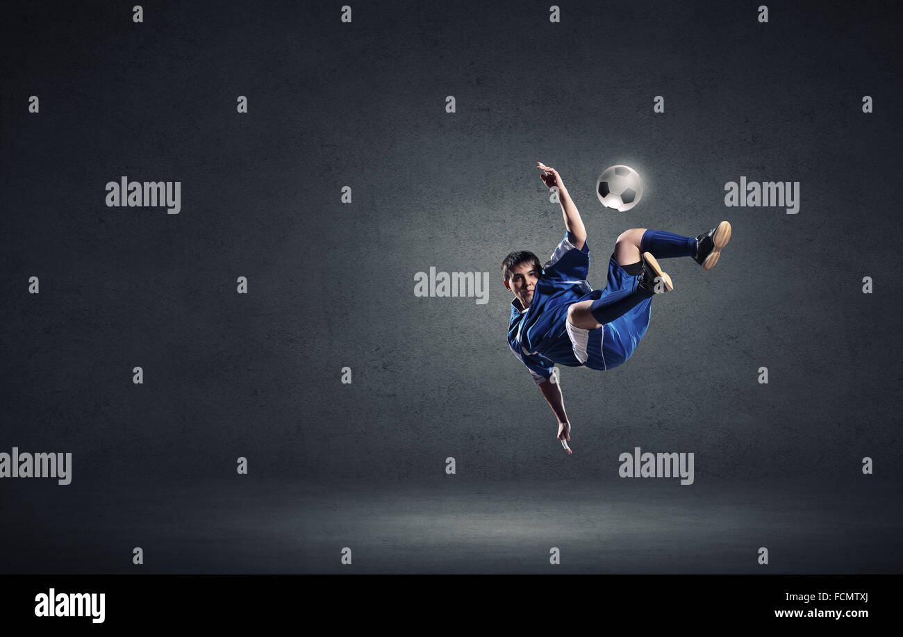 Football player in high jump taking ball Stock Photo - Alamy