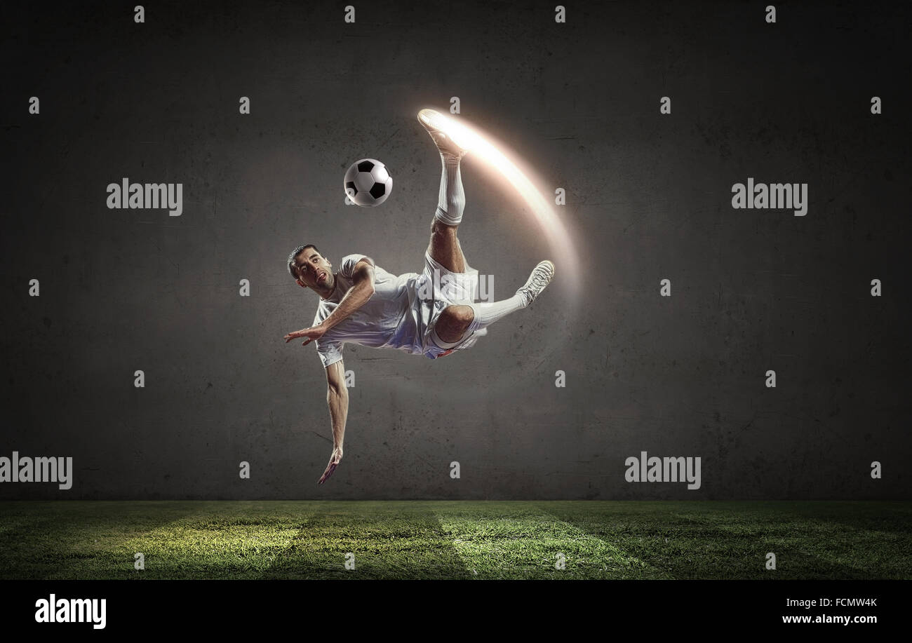 Football player in high jump taking ball Stock Photo - Alamy