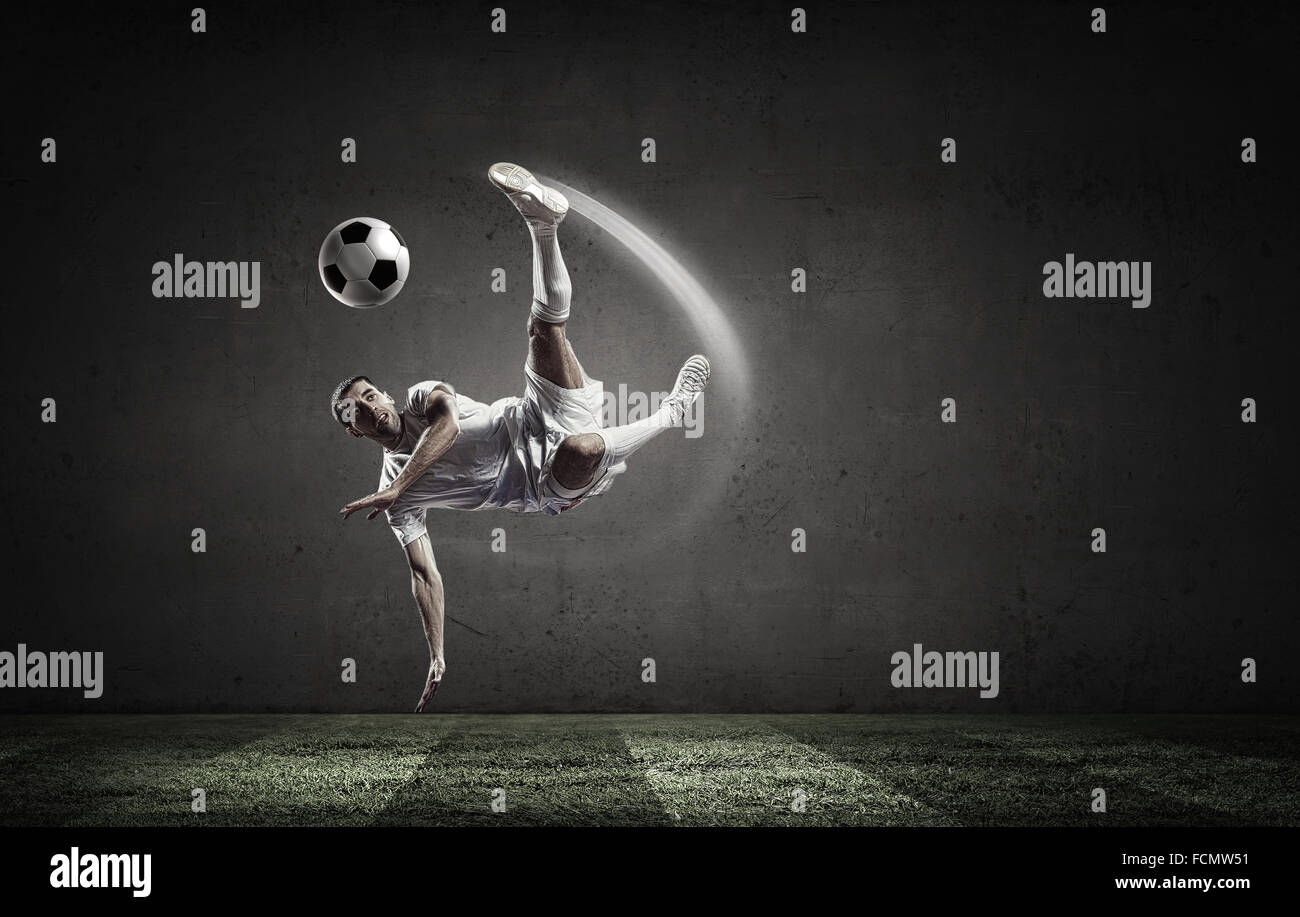 Football player in high jump taking ball Stock Photo - Alamy