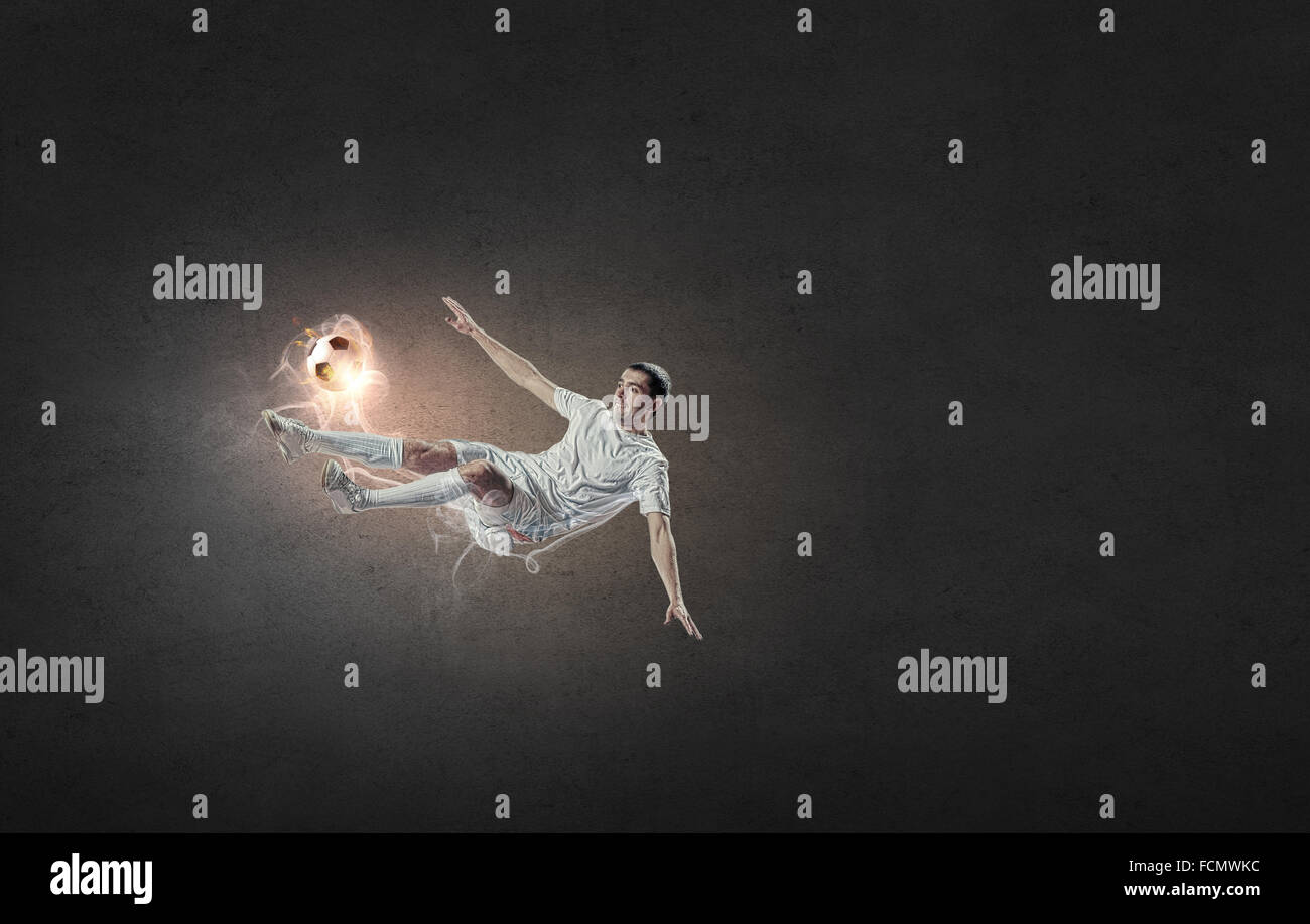 Football player in high jump taking ball Stock Photo - Alamy