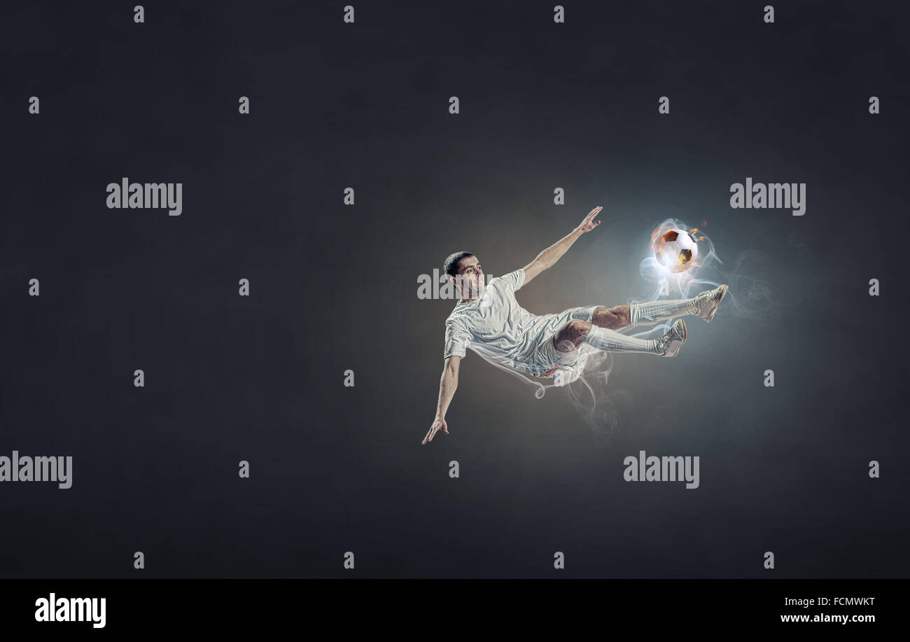 Football player in high jump taking ball Stock Photo - Alamy