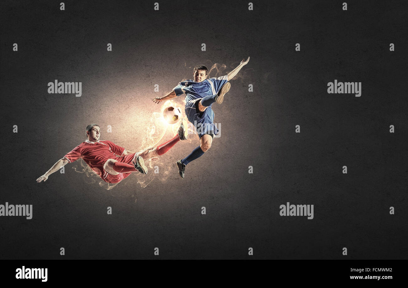 Two football players in jump fighting for ball Stock Photo - Alamy