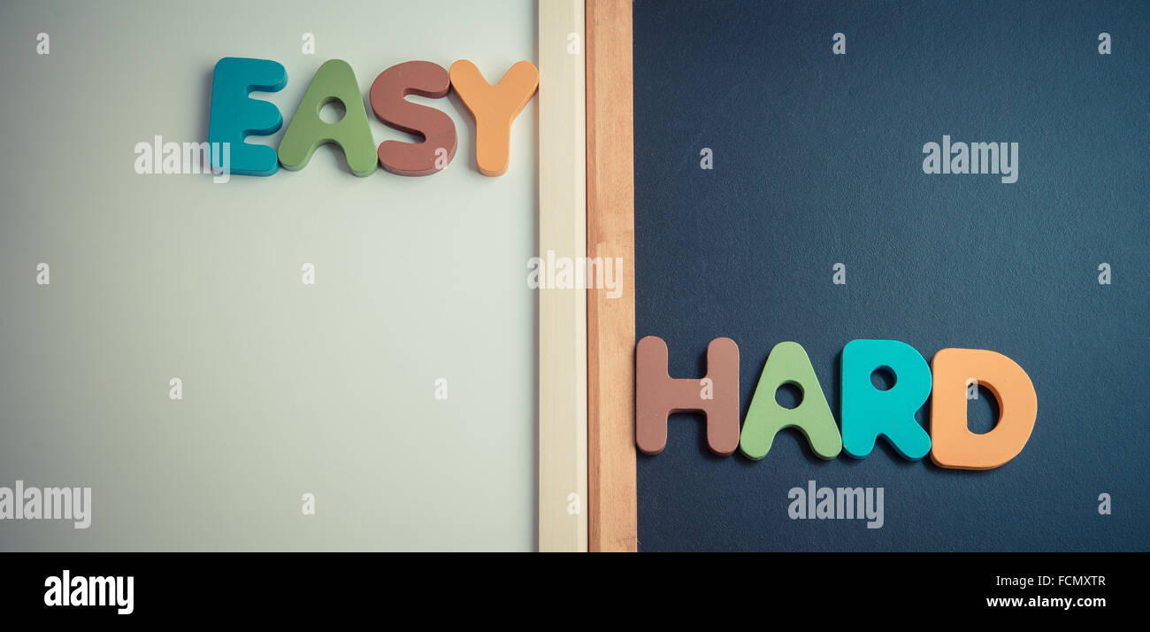 Wooden word EASY and HARD on black board and white board in Vintage ...