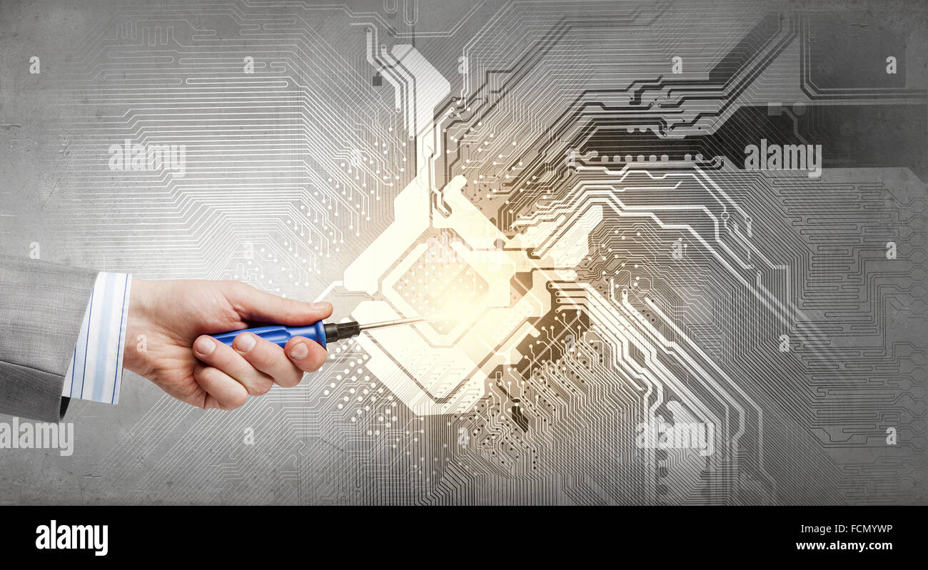 Close up of hand with screwdriver fixing circuit Stock Photo - Alamy