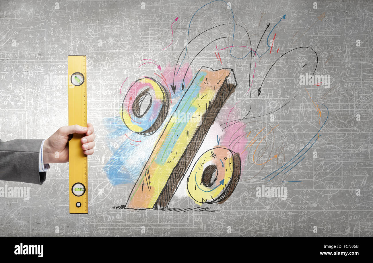 Close up of hand measuring percent symbol with ruler Stock Photo - Alamy