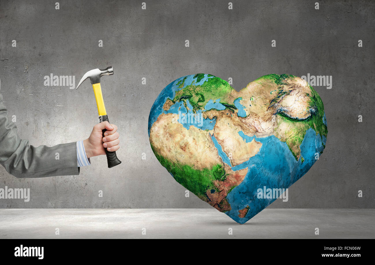 Close up of hammer in human hand hitting Earth planet. Elements of this ...