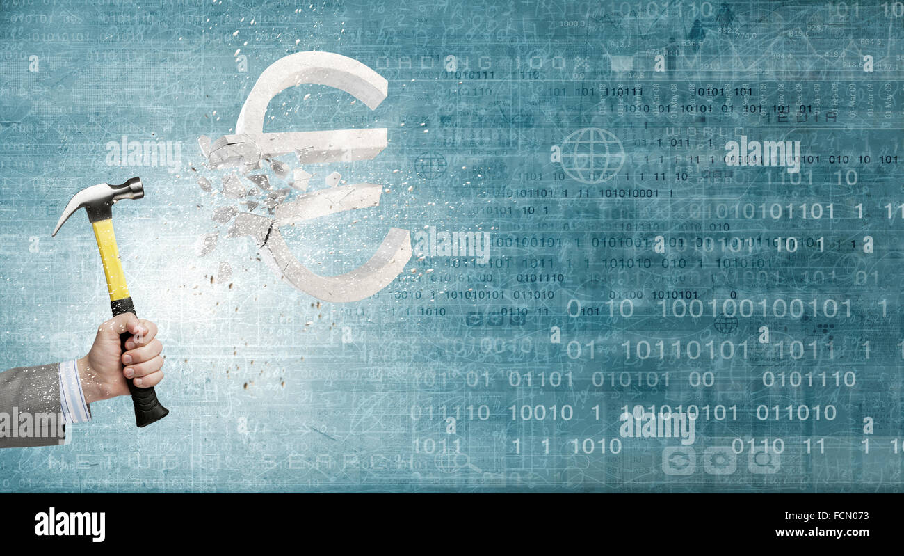 Close up of hammer in human hand breaking stone euro symbol Stock Photo ...