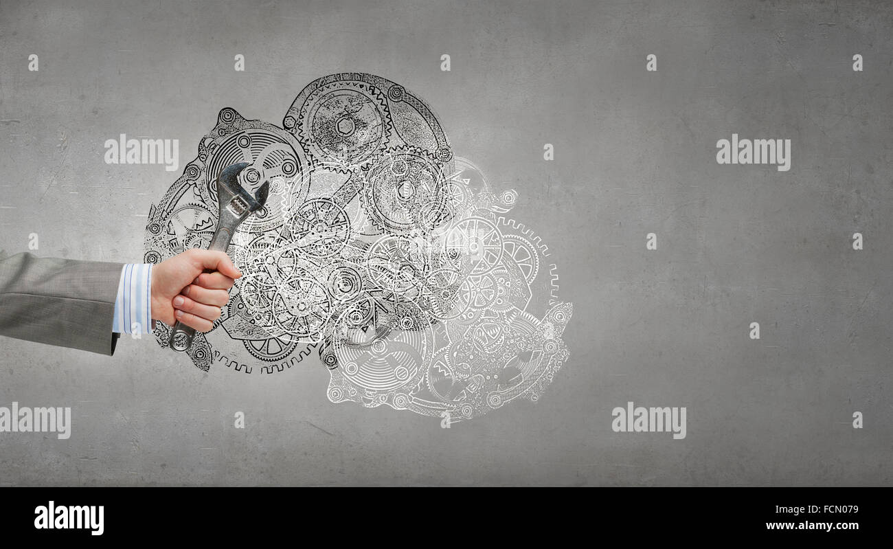 Close up of hand with wrench fixing mechanism Stock Photo - Alamy