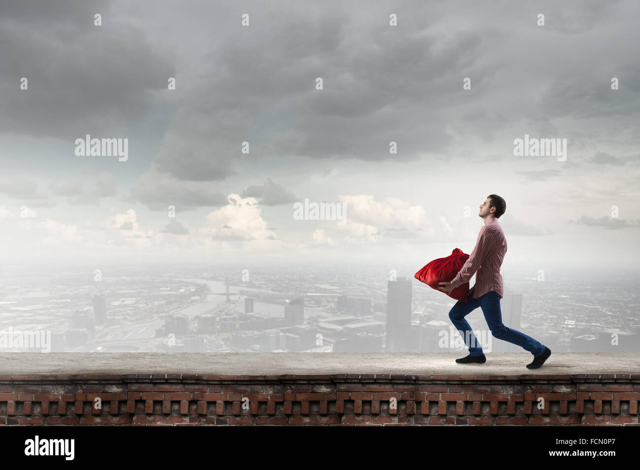 Young man in casual carrying heavy red bag Stock Photo - Alamy