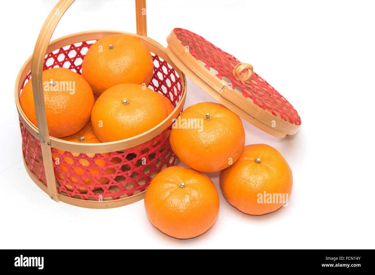 Fresh mandarin oranges in red bamboo basket Stock Photo - Alamy
