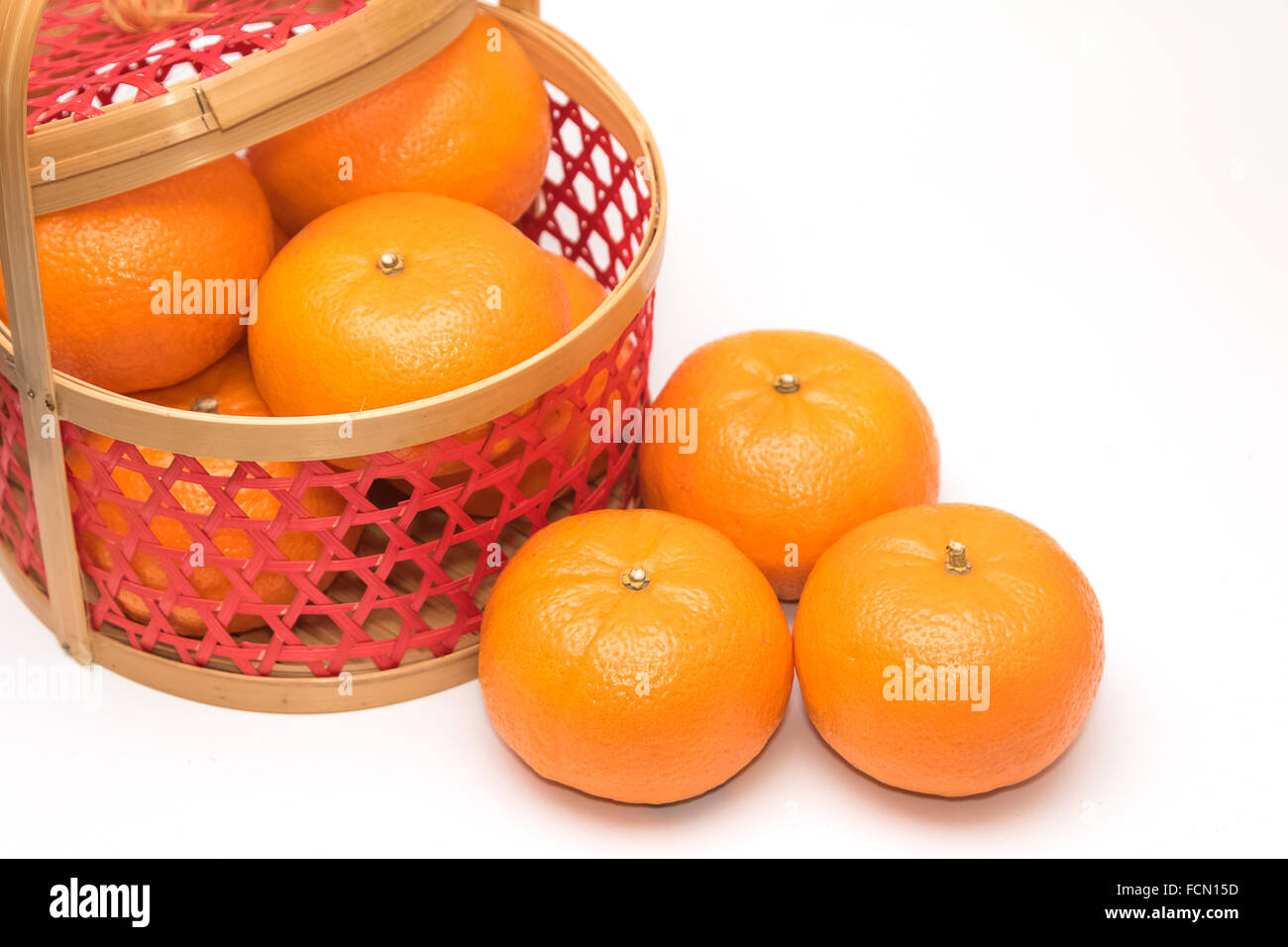Mandarin orange in red basket Stock Photo - Alamy