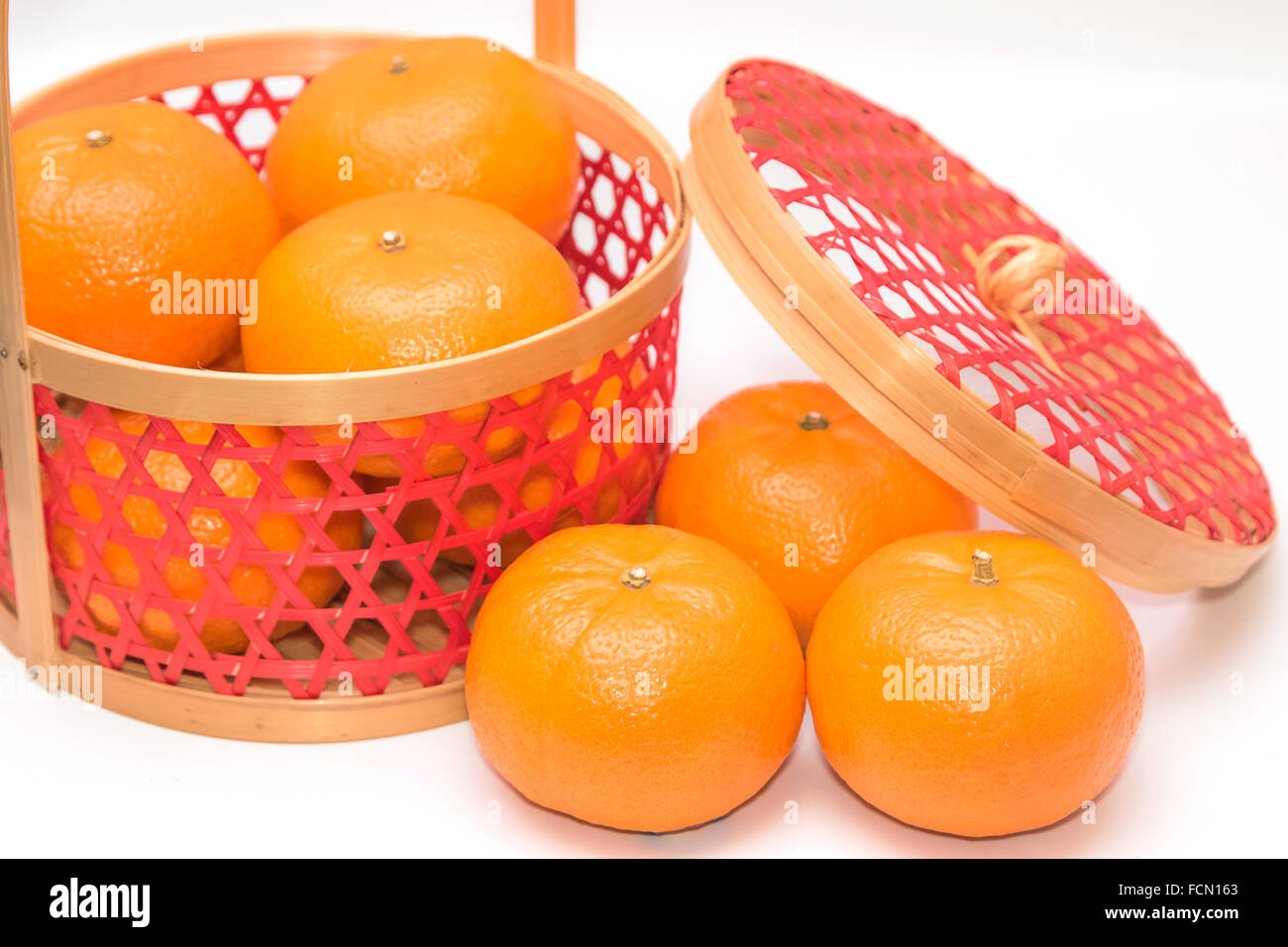 Mandarin orange in red basket Stock Photo - Alamy