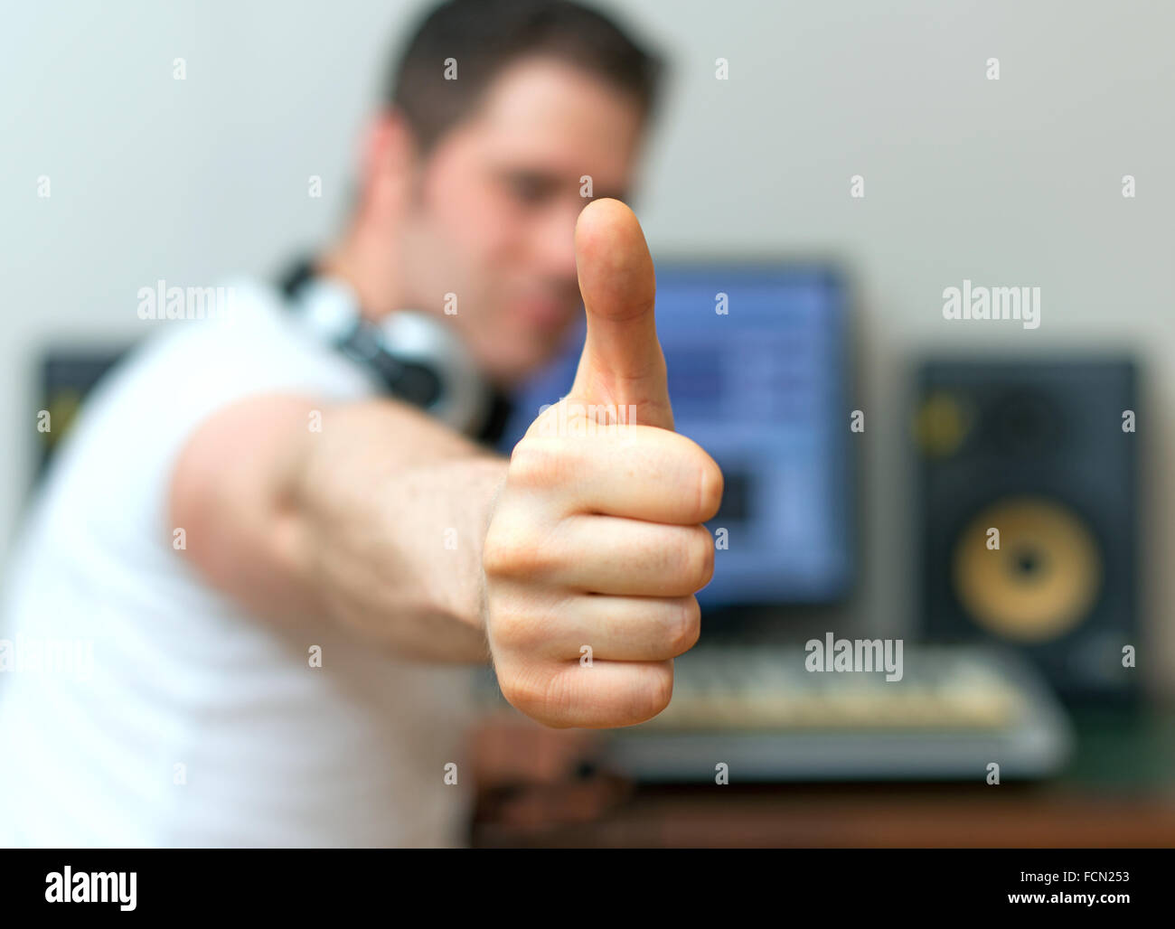 Male sound producer with thumbs up Stock Photo - Alamy