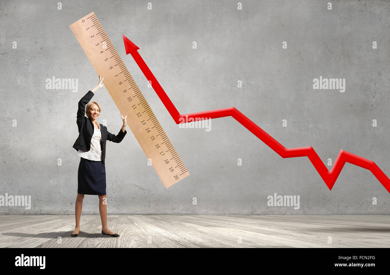 Young businesswoman measuring something with big ruler Stock Photo - Alamy