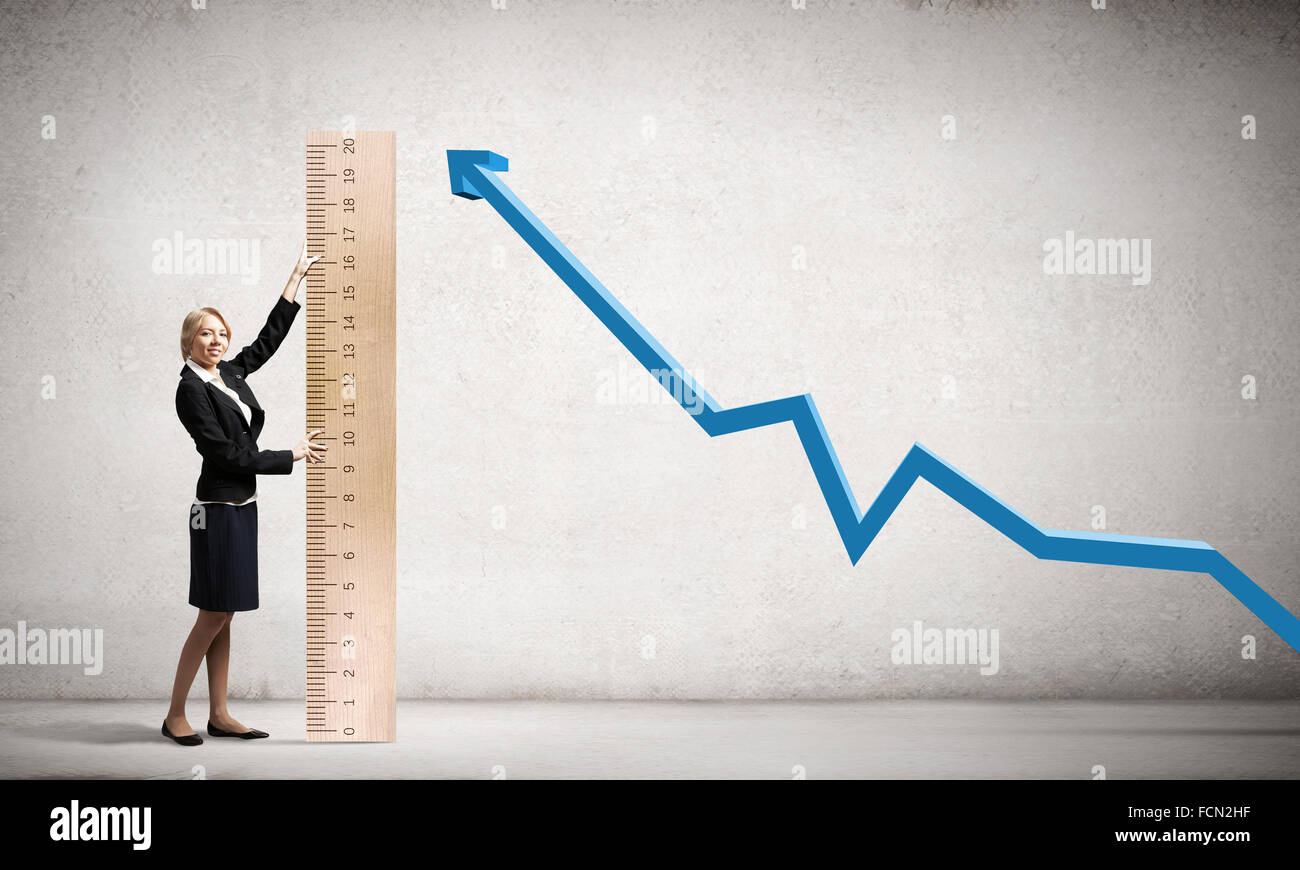 Young businesswoman measuring something with big ruler Stock Photo - Alamy