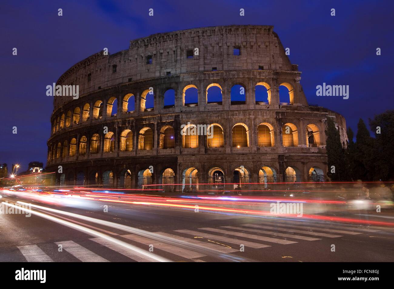 The Roman Colosseum and car light-trails at night, Rome, Lazio, Italy ...