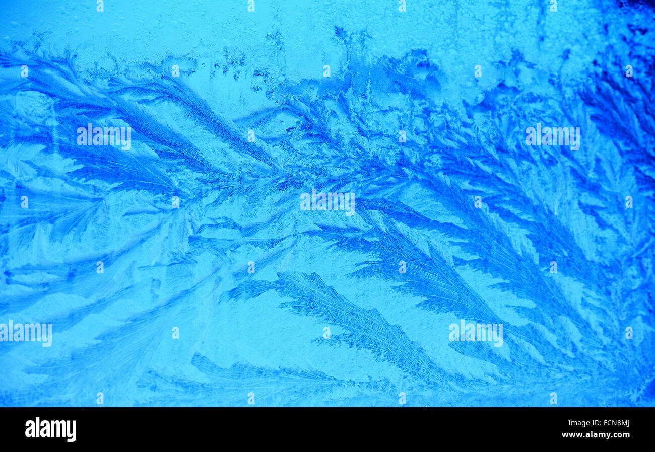 Icy blue frosty ornate pattern of thin ice on the window Stock Photo ...