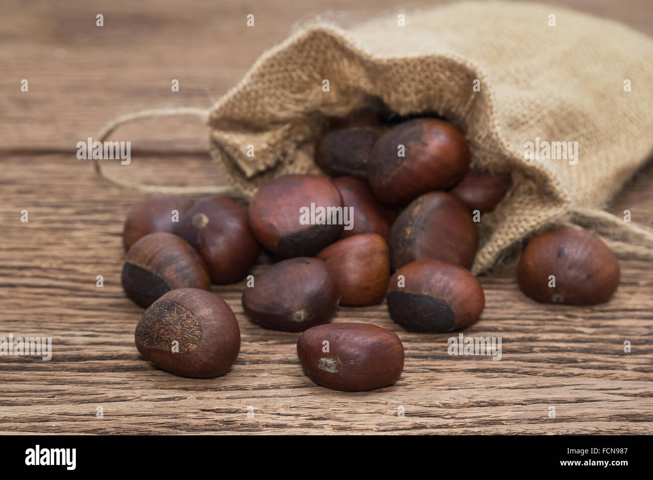 roasted chestnuts in canvas bag on wooden background Stock Photo - Alamy