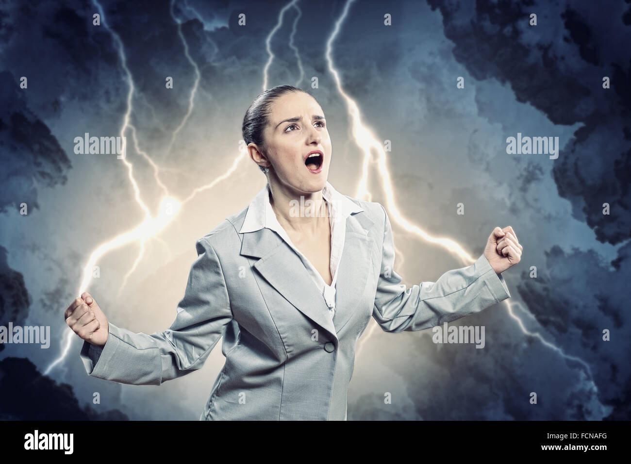 businesswoman in anger screaming against lightning background Stock ...