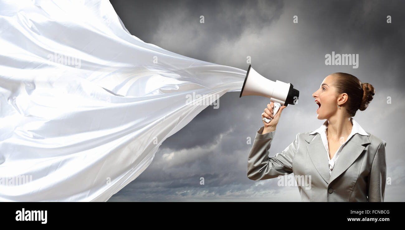 businesswoman in grey suit screaming into megaphone Stock Photo - Alamy