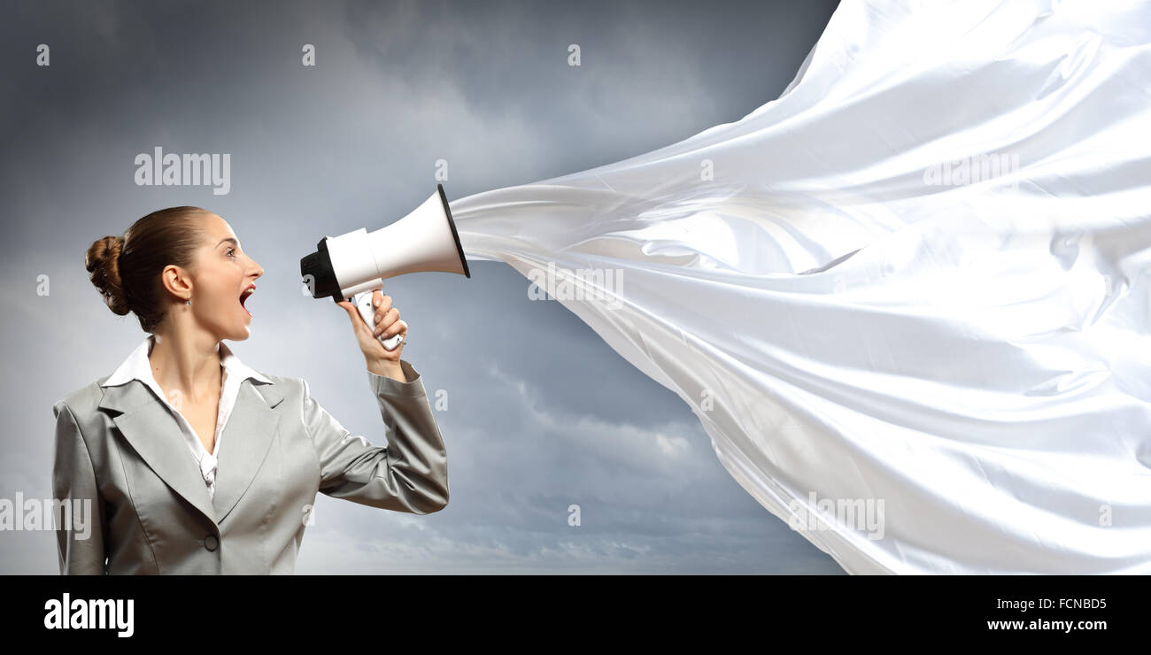 businesswoman in grey suit screaming into megaphone Stock Photo - Alamy