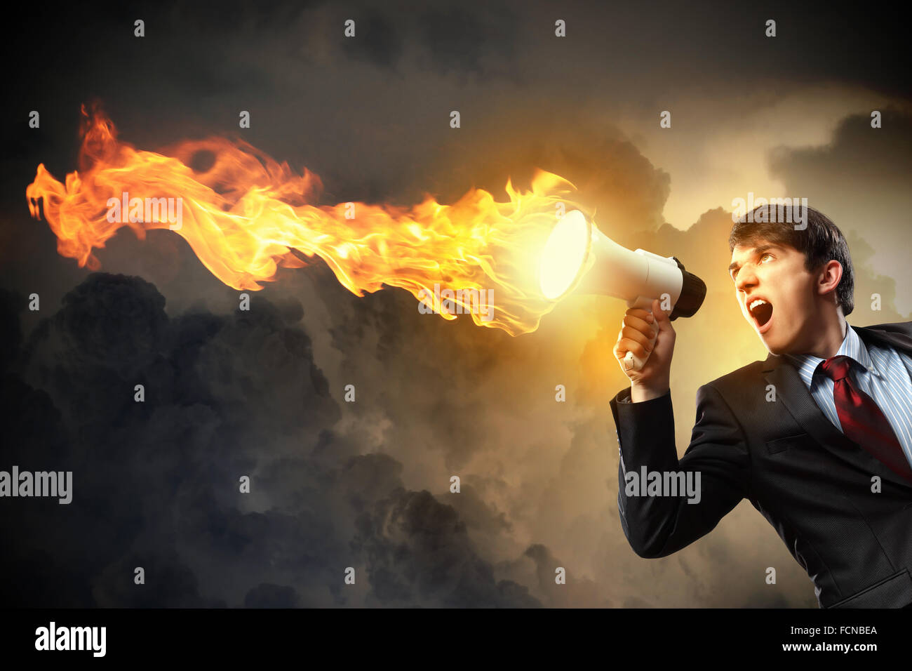 young businessman in black suit screaming into megaphone Stock Photo ...