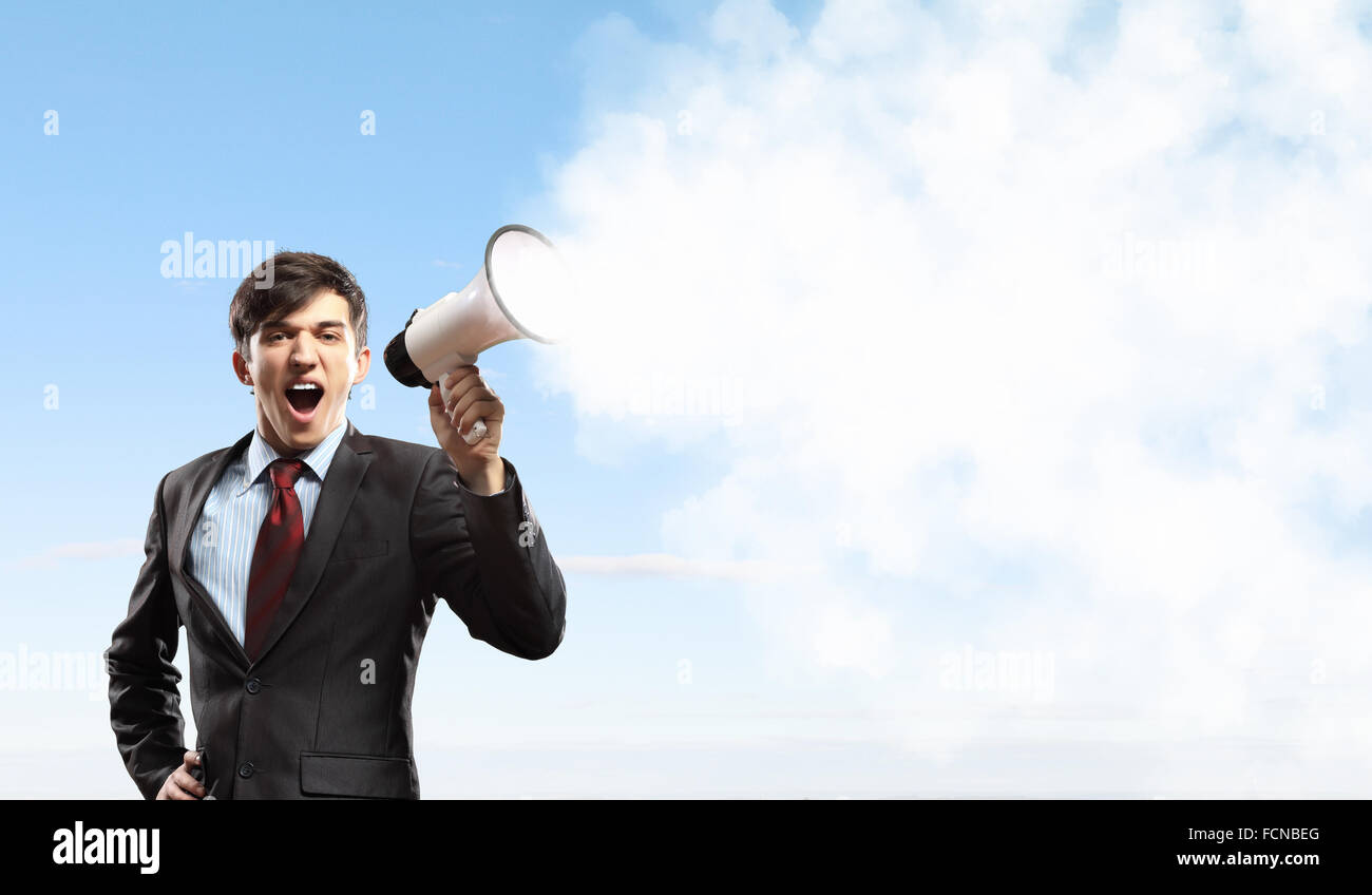young businessman in black suit screaming into megaphone Stock Photo ...