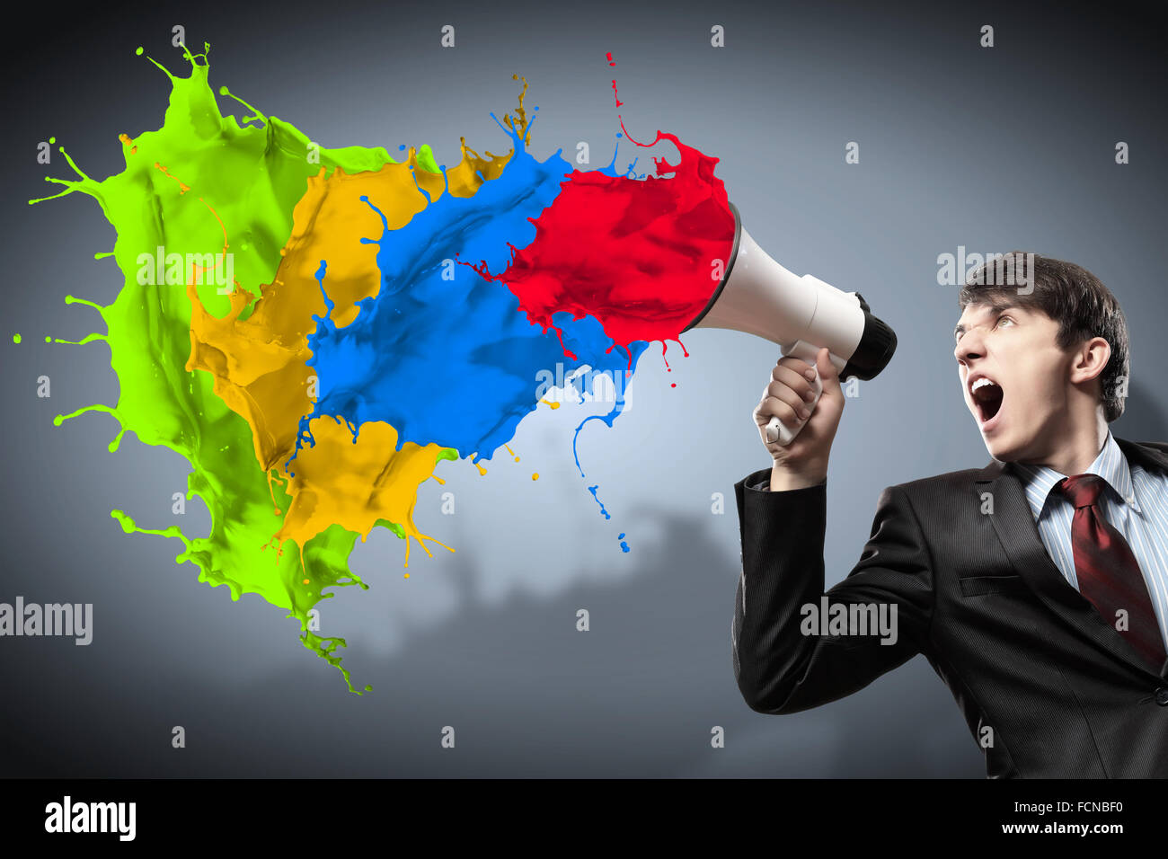 young businessman in black suit screaming into megaphone Stock Photo ...