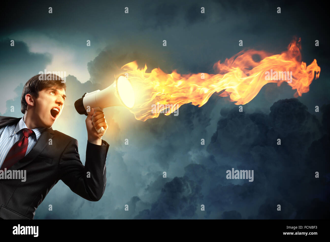 young businessman in black suit screaming into megaphone Stock Photo ...