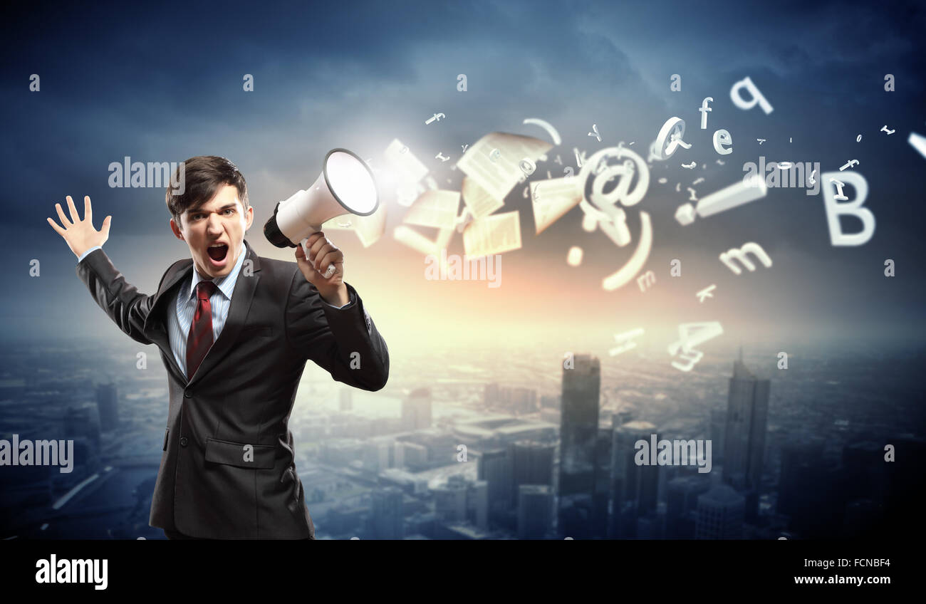 young businessman in black suit screaming into megaphone Stock Photo ...