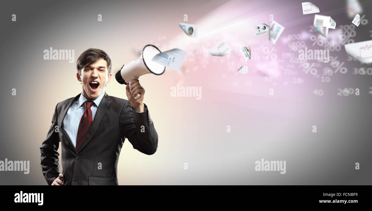 young businessman in black suit screaming into megaphone Stock Photo ...