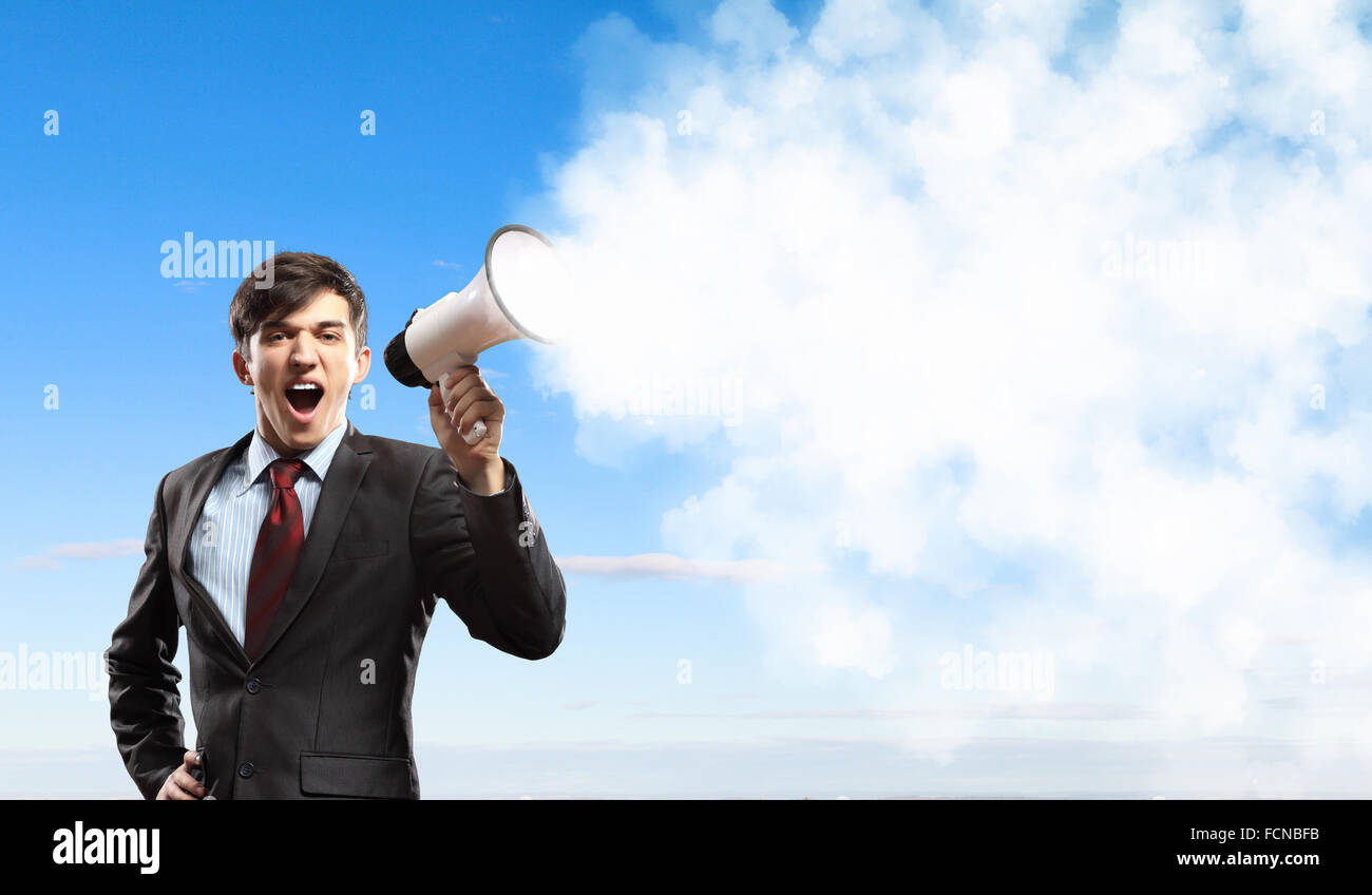 young businessman in black suit screaming into megaphone Stock Photo ...