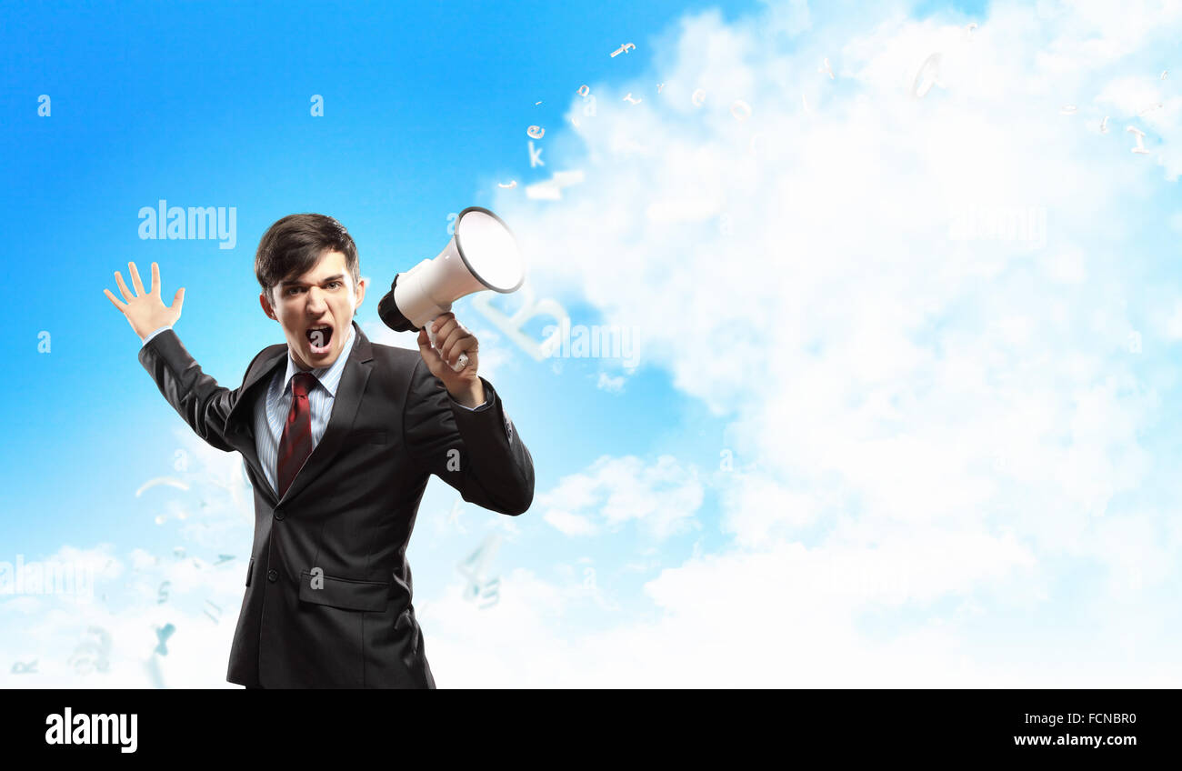 young businessman in black suit screaming into megaphone Stock Photo ...