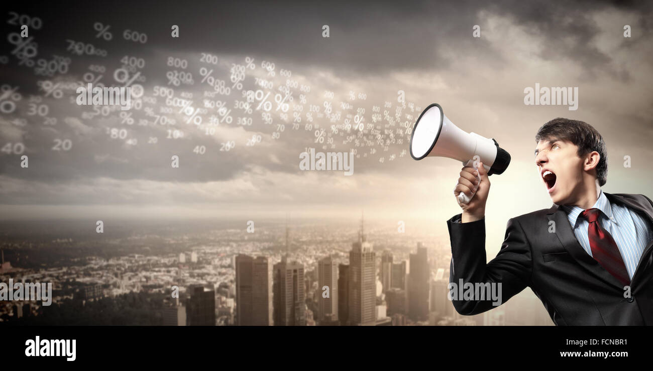 young businessman in black suit screaming into megaphone Stock Photo ...