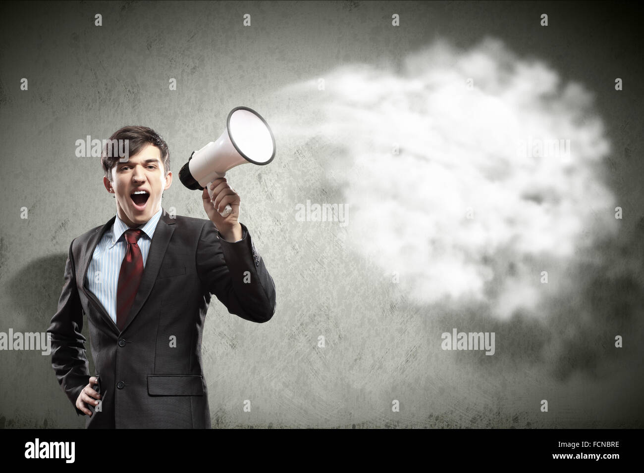 young businessman in black suit screaming into megaphone Stock Photo ...