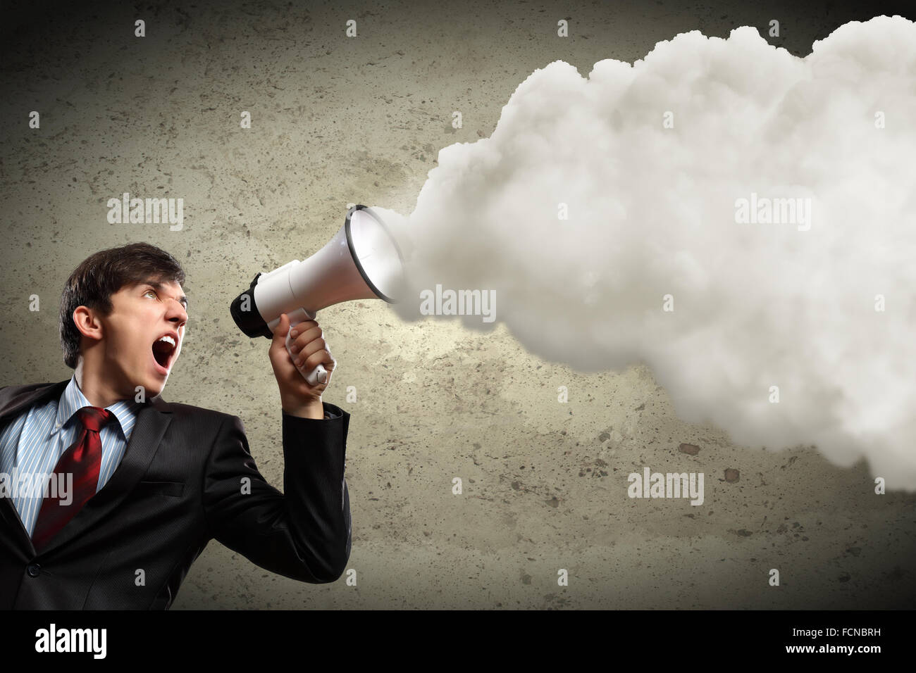 young businessman in black suit screaming into megaphone Stock Photo ...