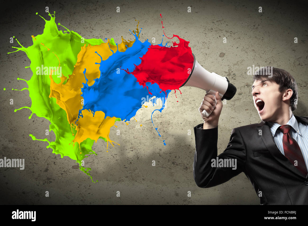 young businessman in black suit screaming into megaphone Stock Photo ...