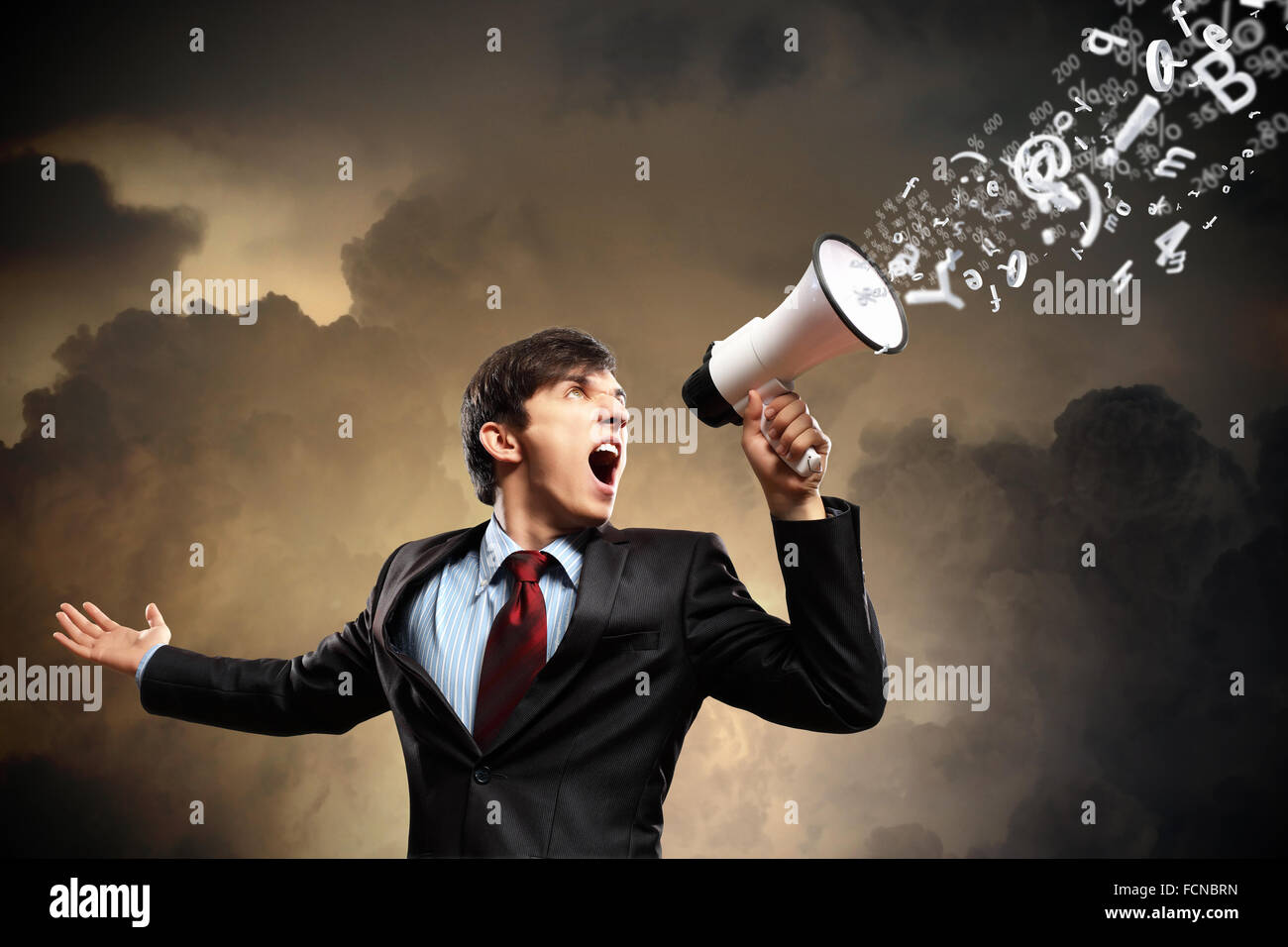 young businessman in black suit screaming into megaphone Stock Photo ...