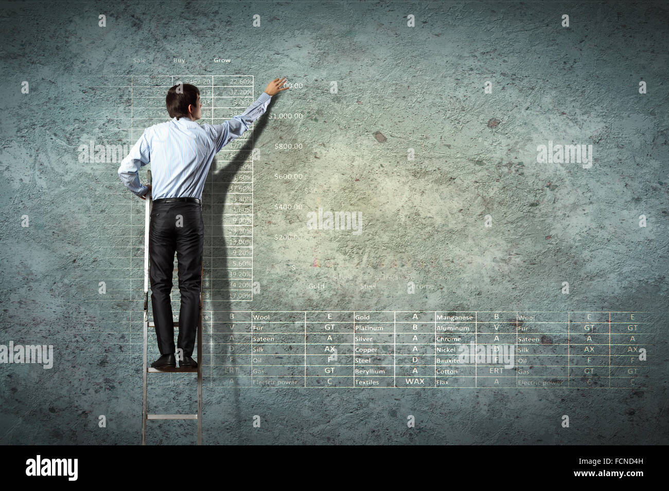 businessman standing on ladder drawing diagrams and graphs Stock Photo ...