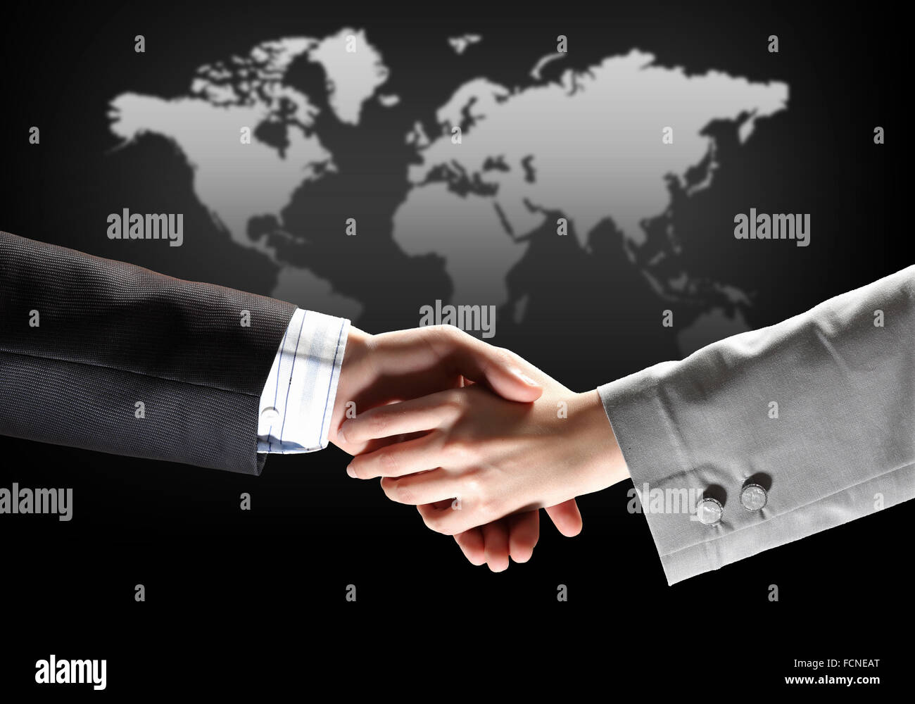 business handshake against black background with map image Stock Photo ...