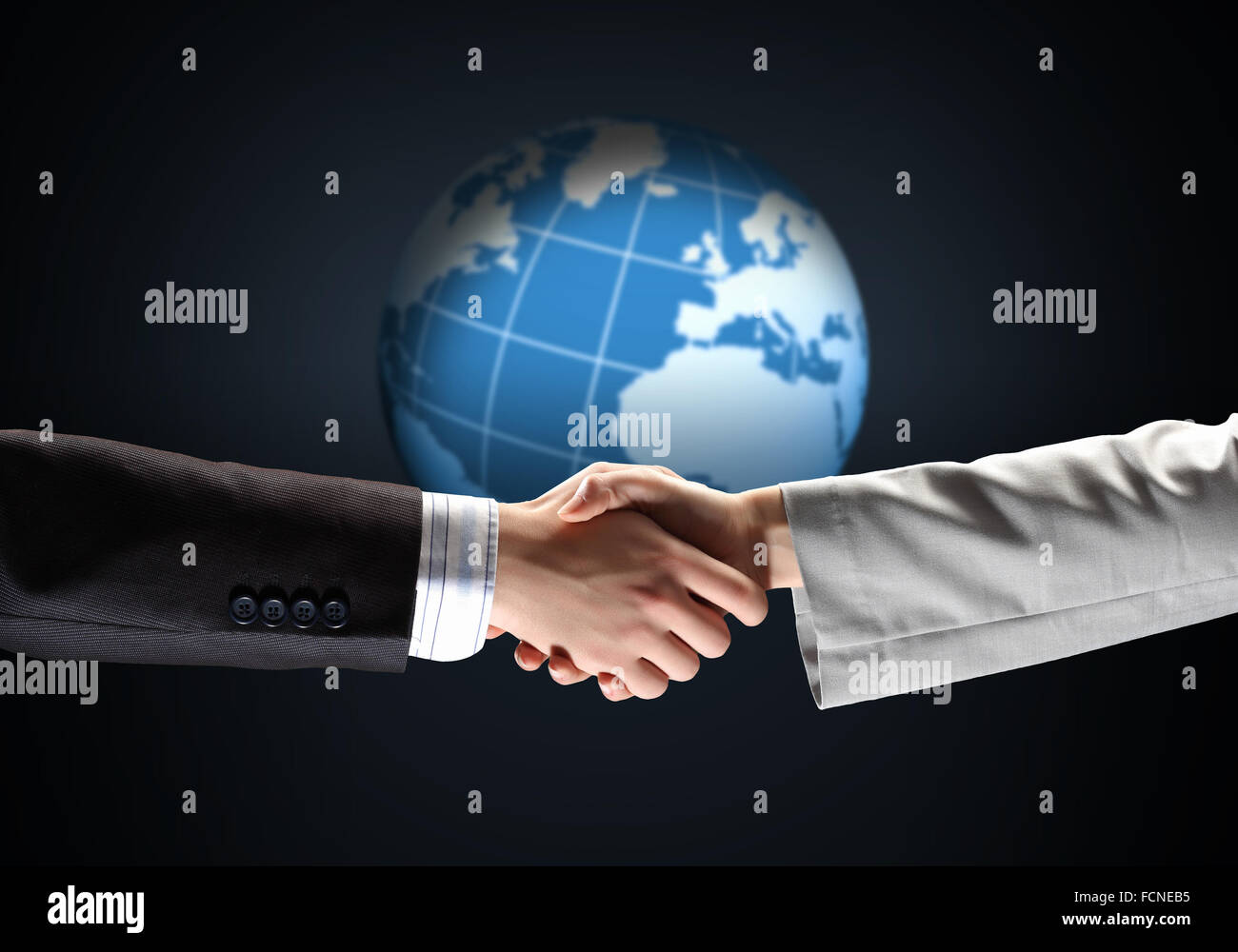 business handshake against black background with globe image Stock ...