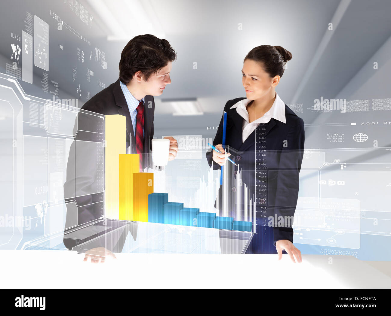 young businesspeople looking at graph of high-tech image Stock Photo ...