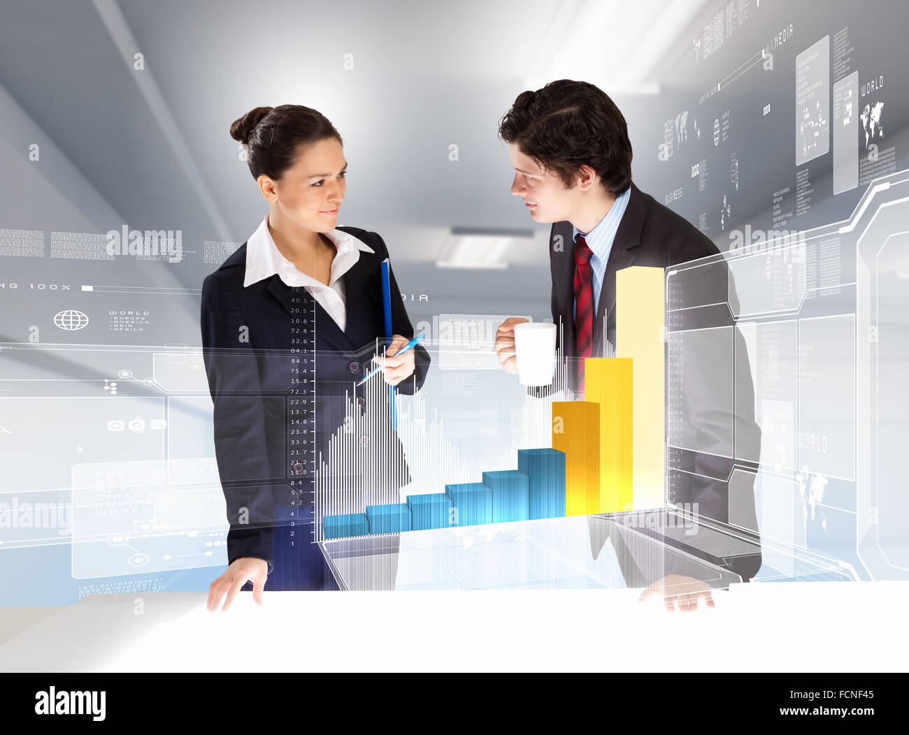 young businesspeople looking at graph of high-tech image Stock Photo ...