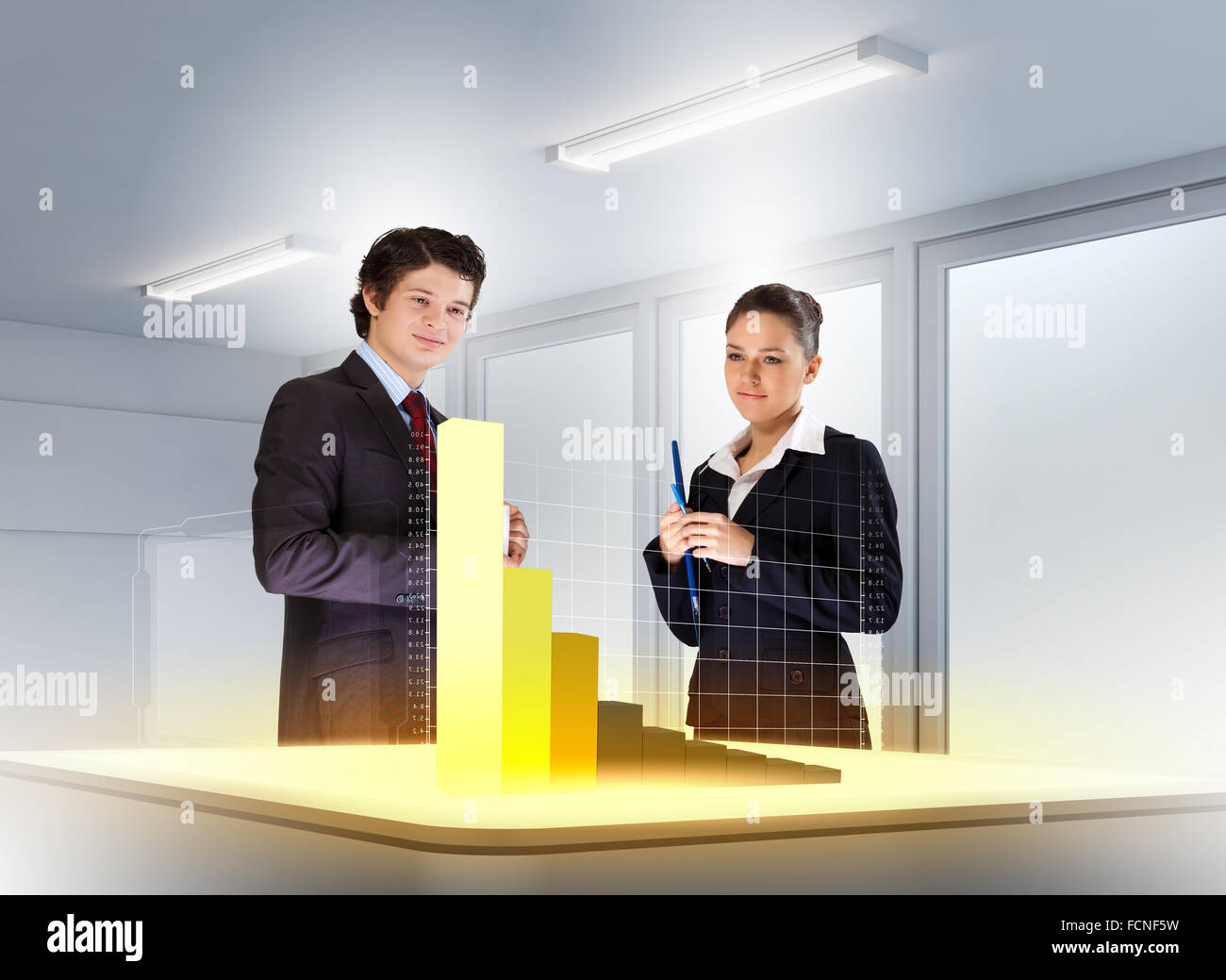 young businesspeople looking at graph of high-tech image Stock Photo ...