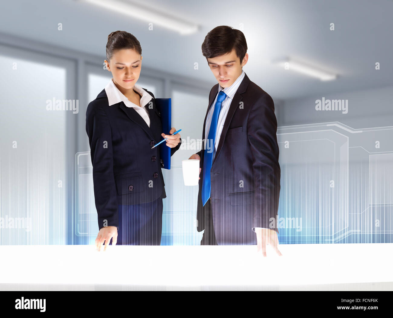 young businesspeople looking standing against high-tech image Stock ...