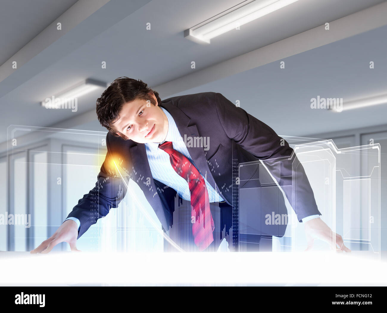 Image of young businessman looking at high-tech picture Stock Photo - Alamy