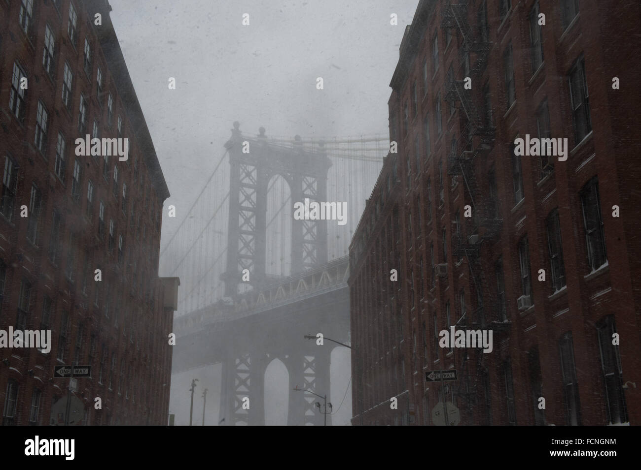 New York, NY, USA. 23rd Jan, 2016. Snow blows past the Manhattan Bridge ...