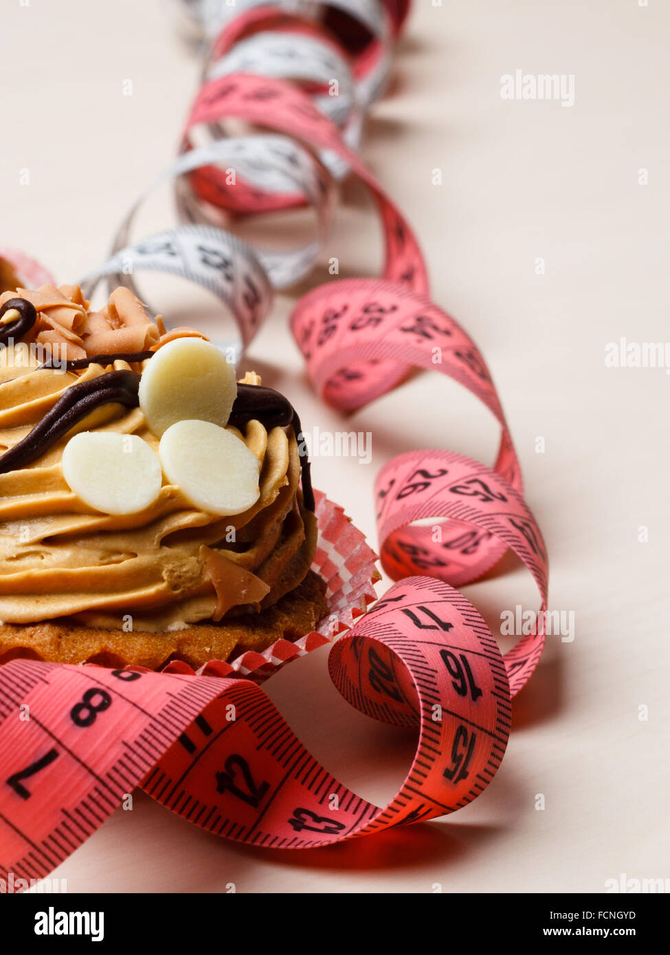 Appetite and gluttony concept. Fattening problem. Cake cupcake with ...