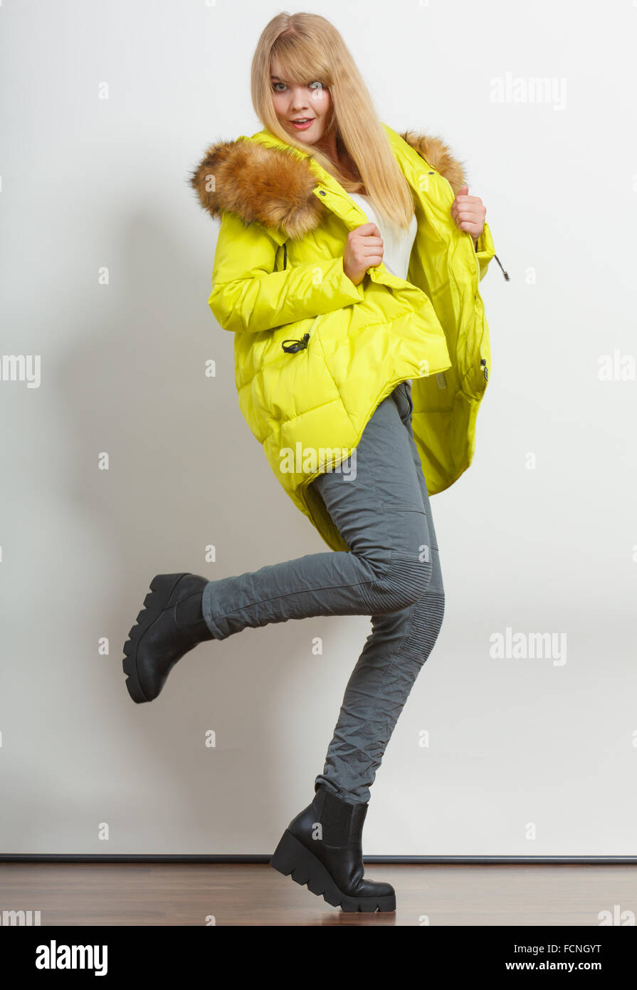 Beautiful smiling young fashionable girl wearing jacket with hood ...